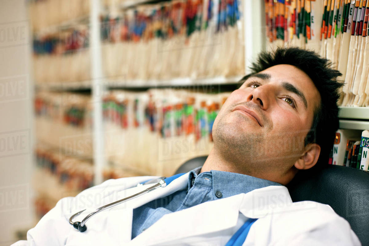 Young doctor sitting back and daydreaming. - Royalty-free Stock Photo ...