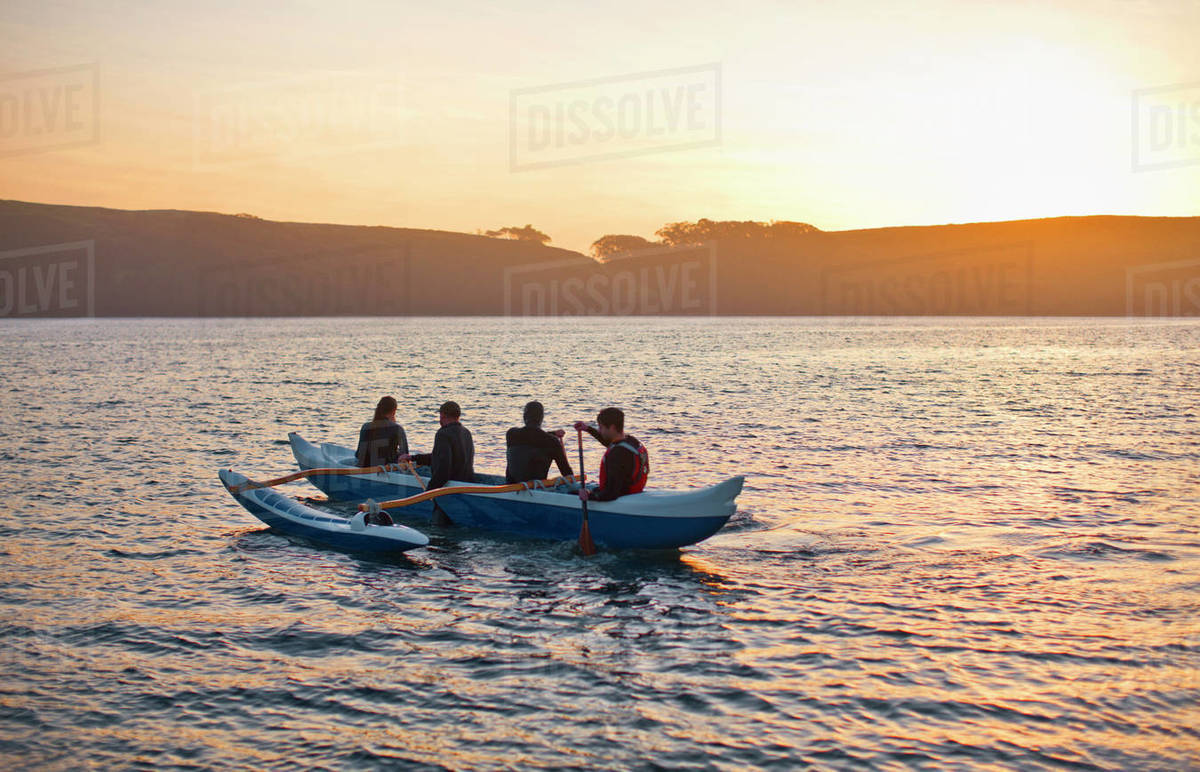 Group of friends rowing on a lake. - Royalty-free Stock Photo | Dissolve