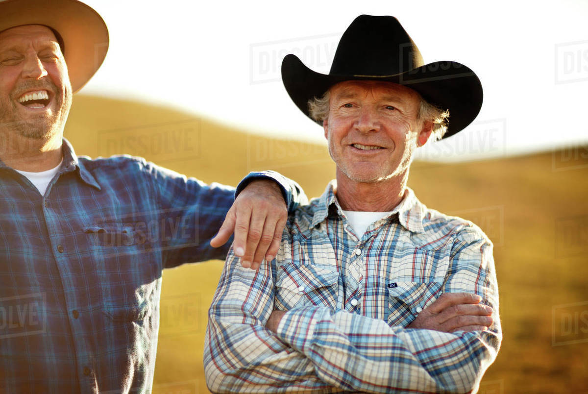 Two farmers laughing on a paddock. - Stock Photo - Dissolve