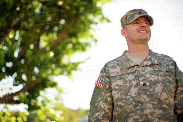 Smiling male army soldier in uniform. - Stock Photo - Dissolve