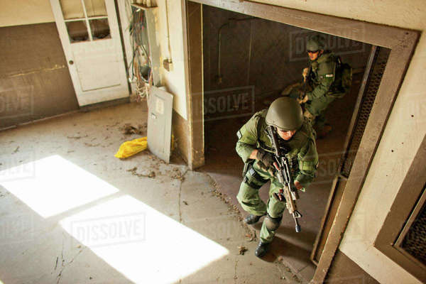 Two police officers inside a building during a exercise at a training ...
