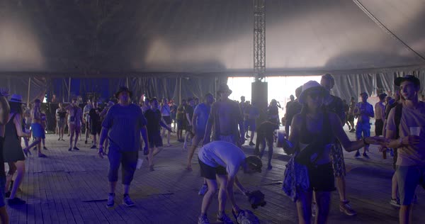 group people make dance moves blue light dance floor They move their ...