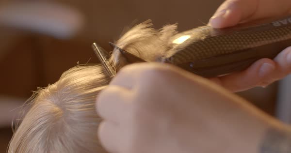 The movement of the clipper through the hair. Cutting off small pieces ...