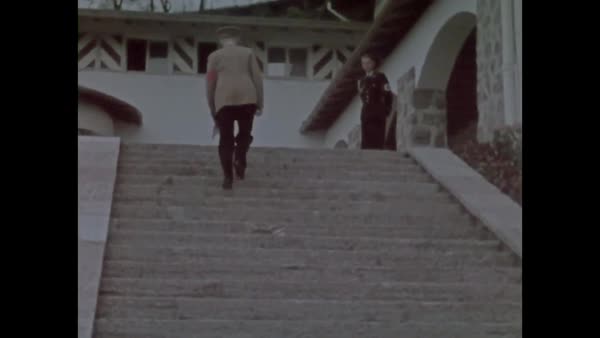 World War Two. Adolf Hitler wear a uniform. He walks upstairs to the ...
