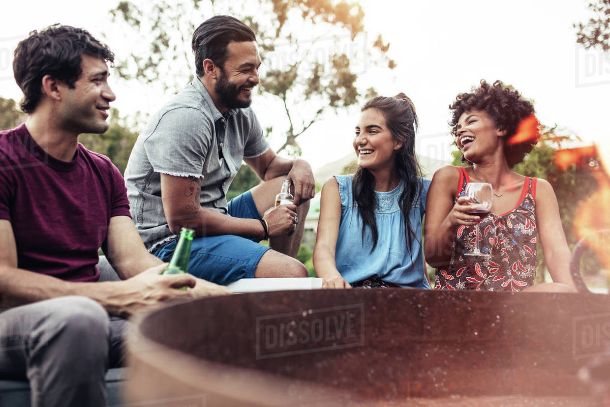 Group of young people having a party with beers and drinks. Young men ...