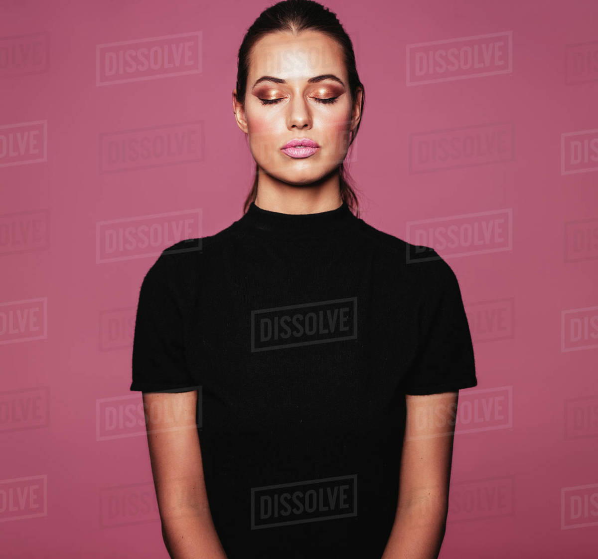 Portrait of caucasian female model standing with her eyes closed ...