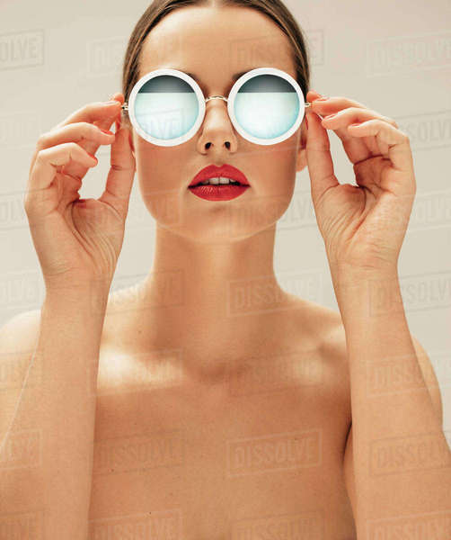 Close up portrait of shirtless female model wearing sunglasses ...