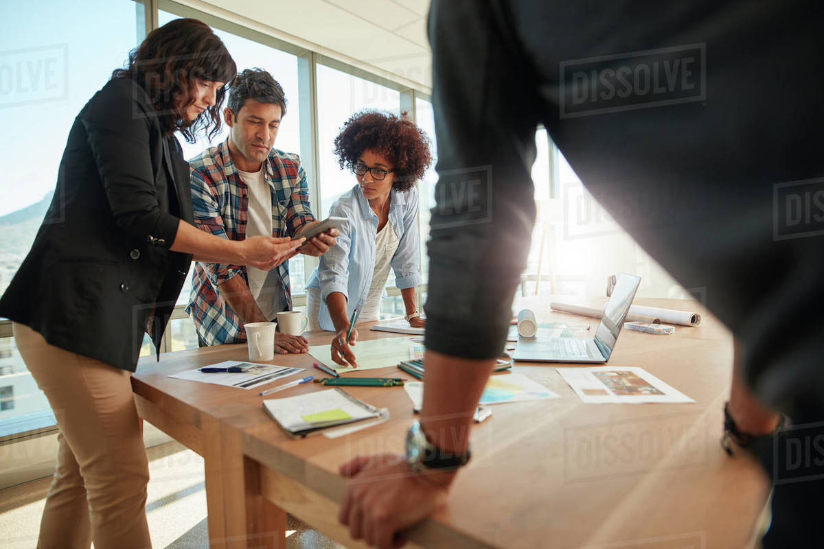 Group of young business people working together around table in ...