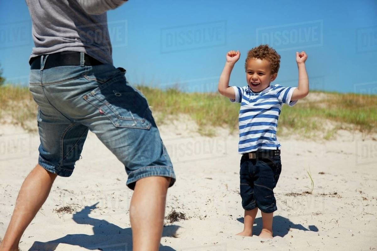Cheerful boy looking excited with a winner expression as he plays with ...