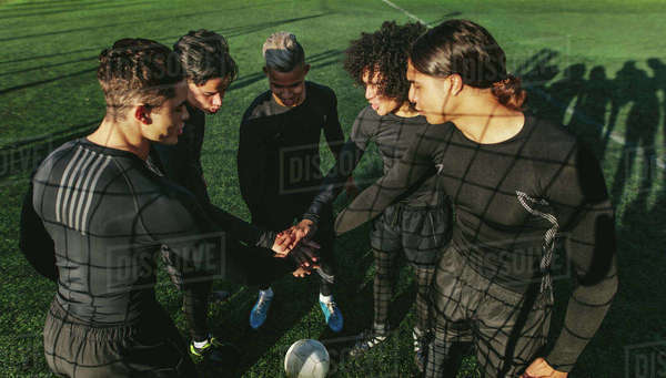 Five a side football team putting their hands together. Soccer players ...