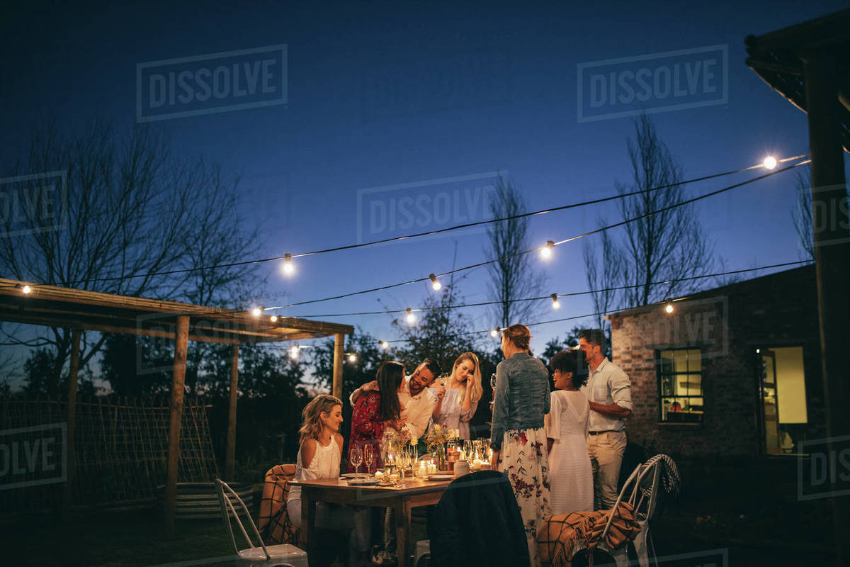 Friends making big party in the night. Group of people having at garden ...