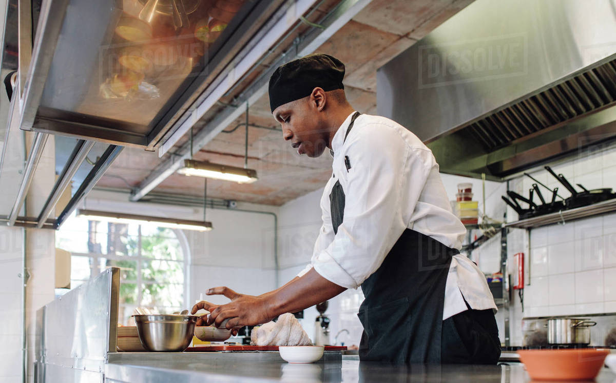 Restaurant chef preparing food. Chef working in a commercial kitchen ...
