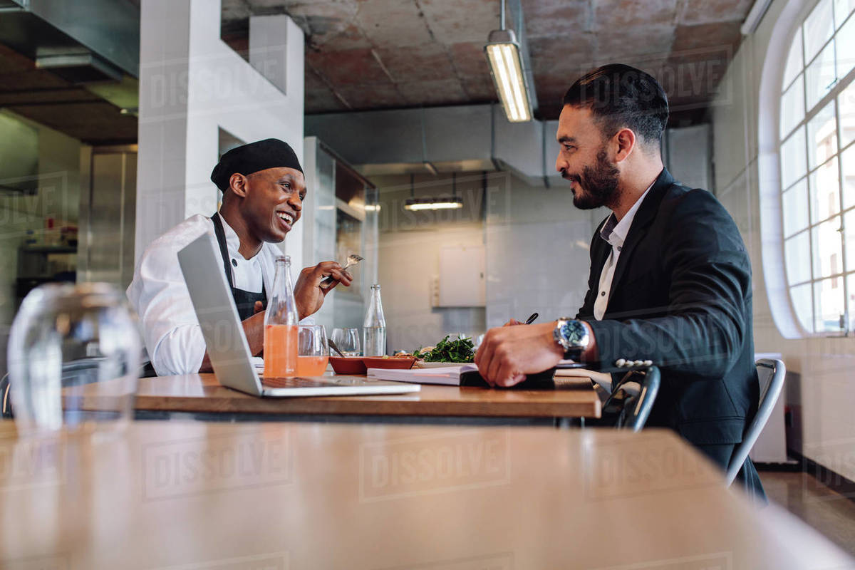 Restaurant business manager sitting and talking with chef. Restaurant ...