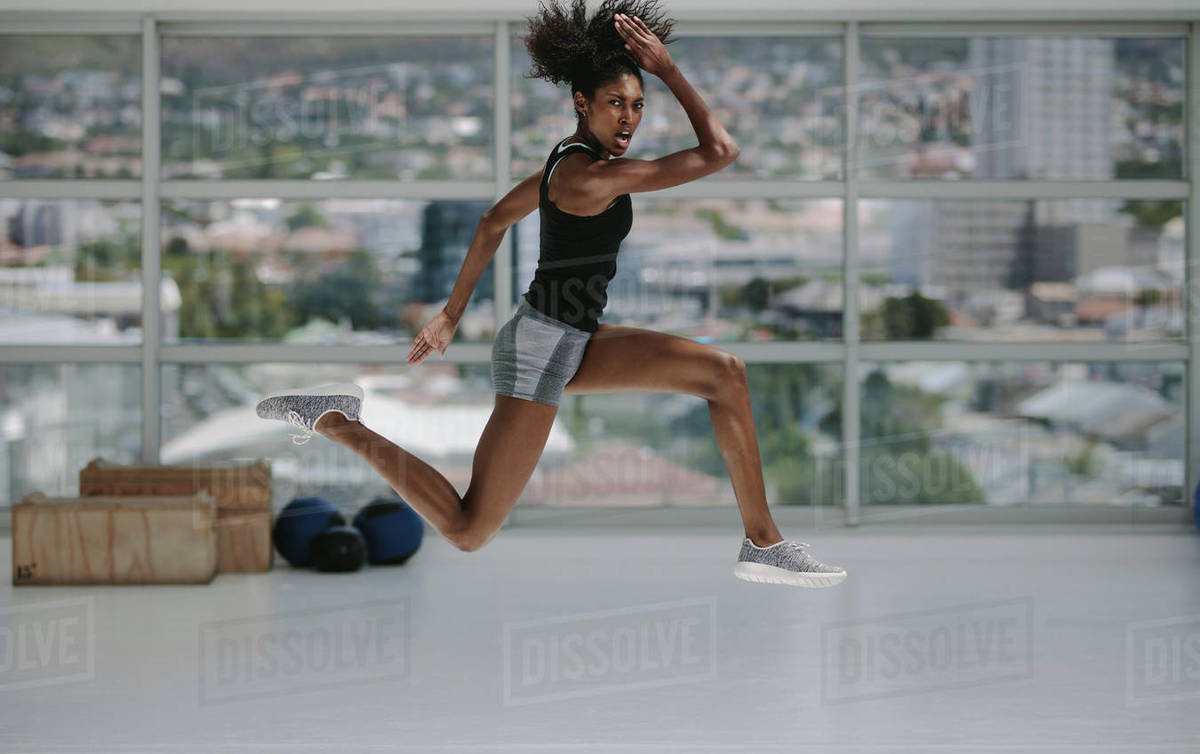 Sporty woman doing intense exercises at fitness studio. Female ...