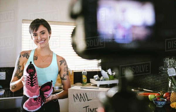 Female vloggers making video at home about sports shoes. Woman vlogger ...