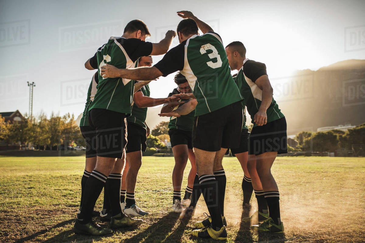 Rugby players cheering together after the game. Rugby team putting ...