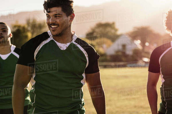 Portrait of happy young rugby player in uniform smiling after the game ...