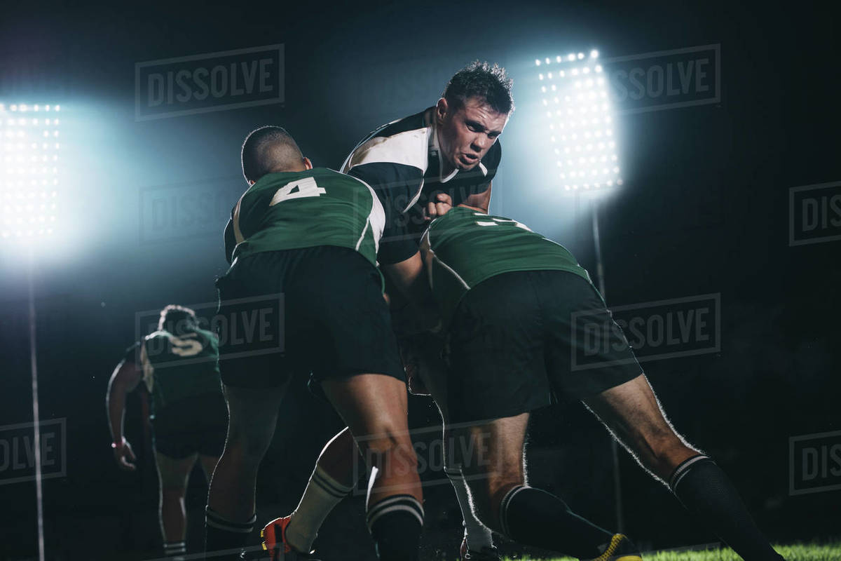 Rugby players fighting for the ball during the night game. Rugby player ...