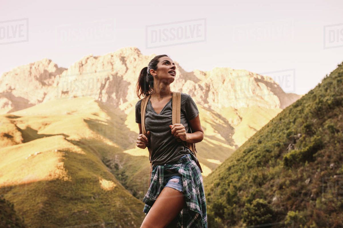 Woman hiking in mountains and looking at the landscape. Female hiker ...