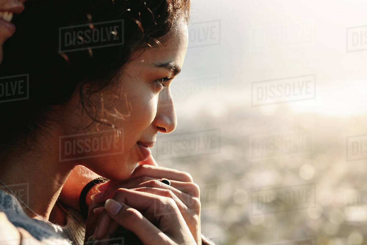 Close up of young woman face looking at a view outdoors. Female being ...