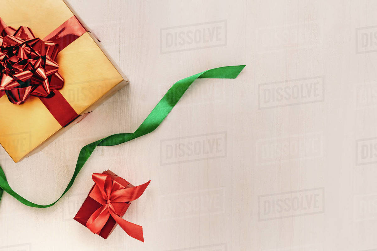 Gift boxes with ribbon on wooden background. Gift boxes wrapped ...