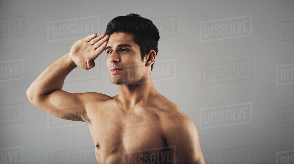 Portrait of young muscular man saluting. Masculine young man doing a ...