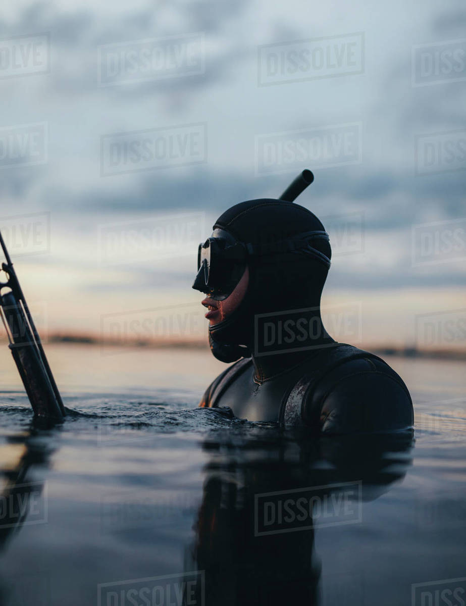 Underwater hunter in sea water to hunt with speargun. Male spearfishing ...