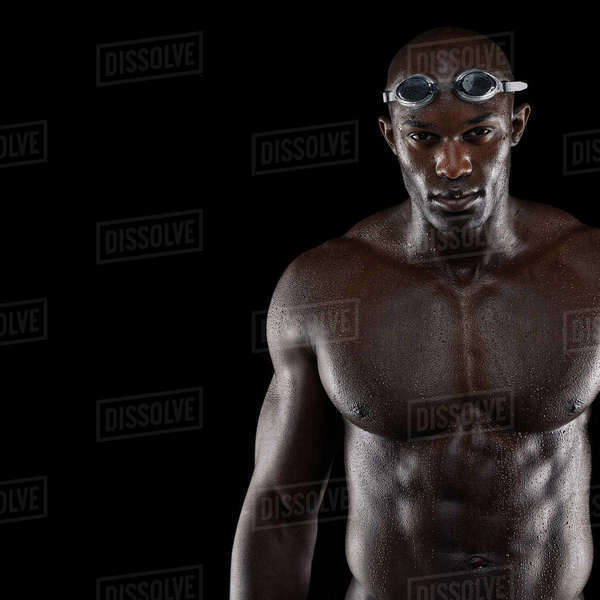 Studio shot of professional male swimmer with copyspace. Young african ...