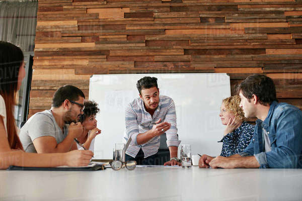 Brainstorming in a boardroom of creative office . Young creative people ...