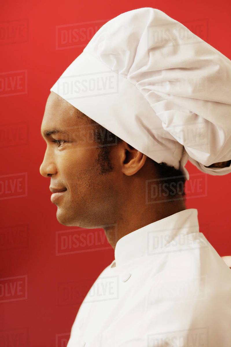 Side view of male chef wearing hat - Royalty-free Stock Photo | Dissolve