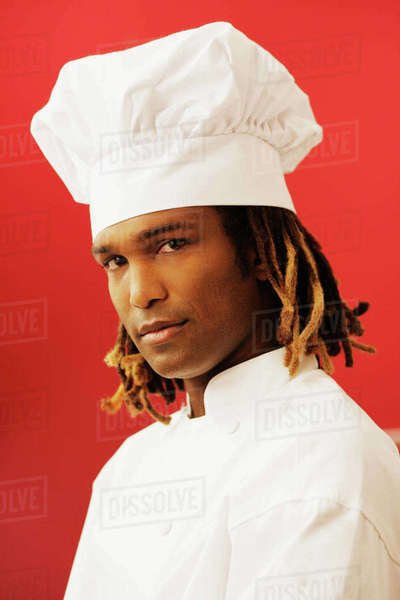 Portrait of male chef wearing hat - Royalty-free Stock Photo | Dissolve