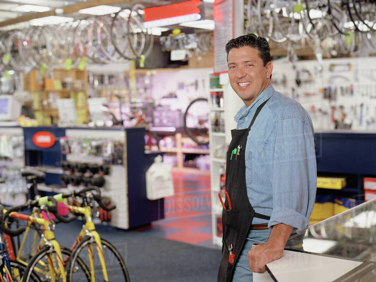 Bike salesman smiling for the camera - Royalty-free Stock Photo | Dissolve