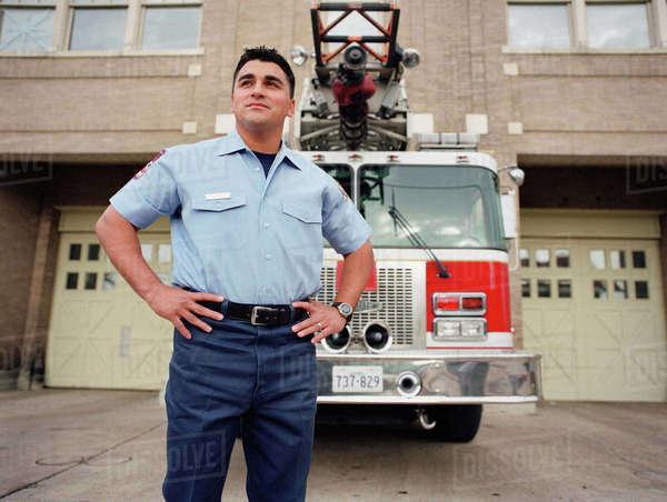 Fireman posing for the camera by fire engine - Royalty-free Stock Photo ...