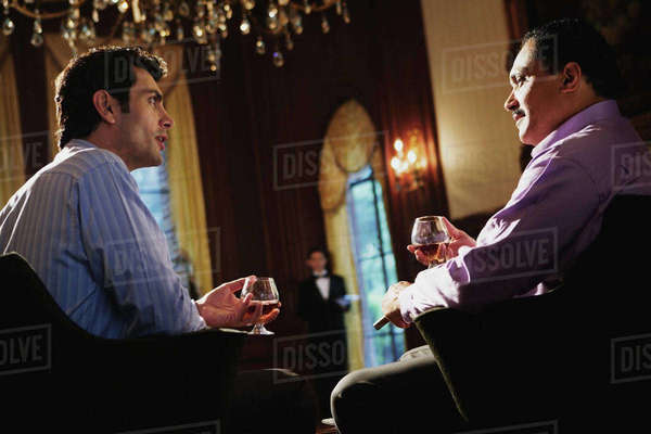 Two men drinking and talking - Royalty-free Stock Photo | Dissolve