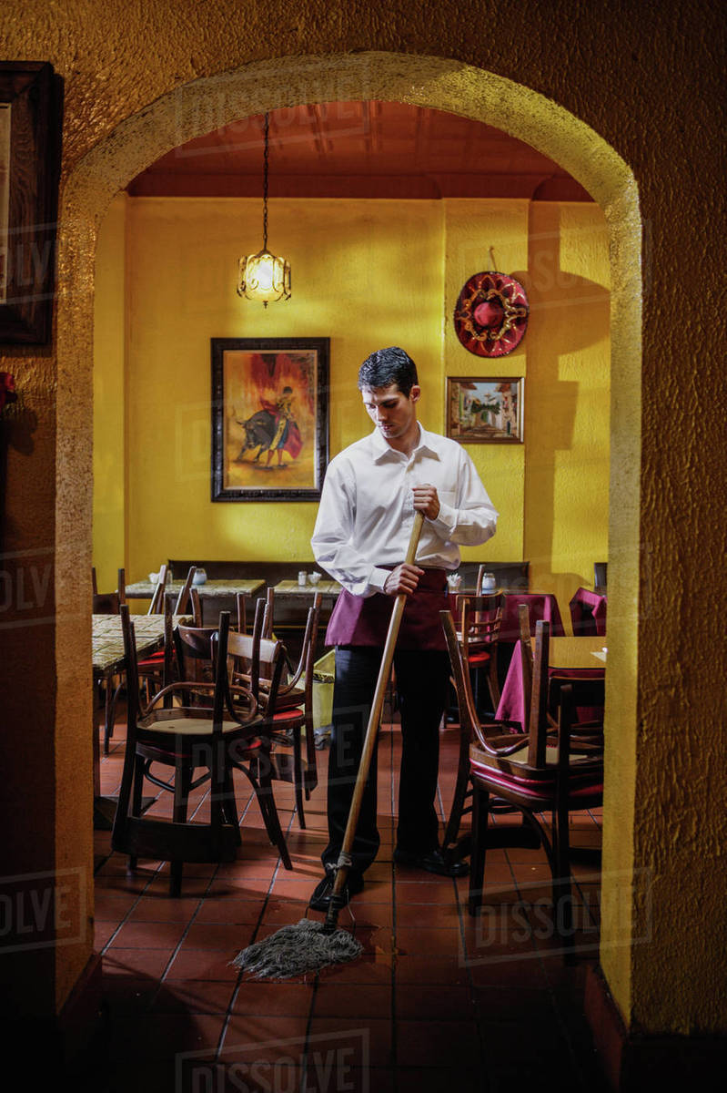Man mopping restaurant floor - Royalty-free Stock Photo | Dissolve