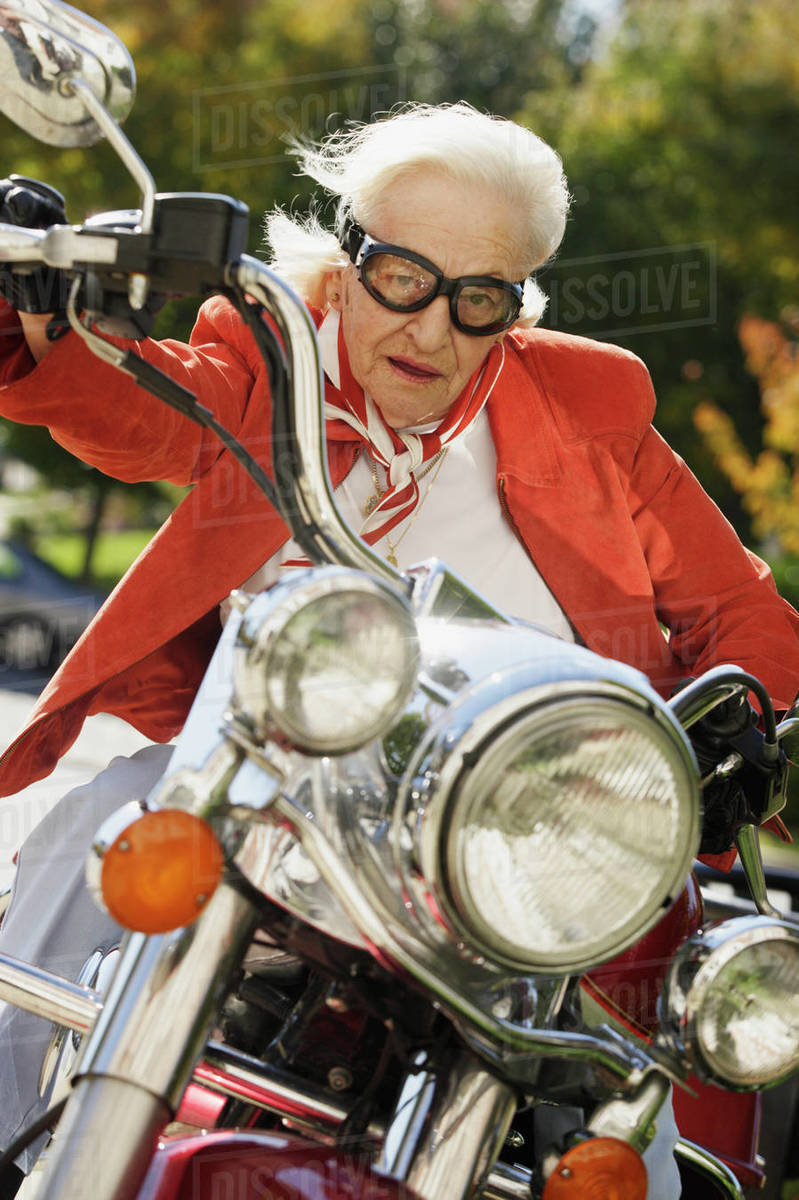 Elderly woman driving a motorcycle - Royalty-free Stock Photo | Dissolve