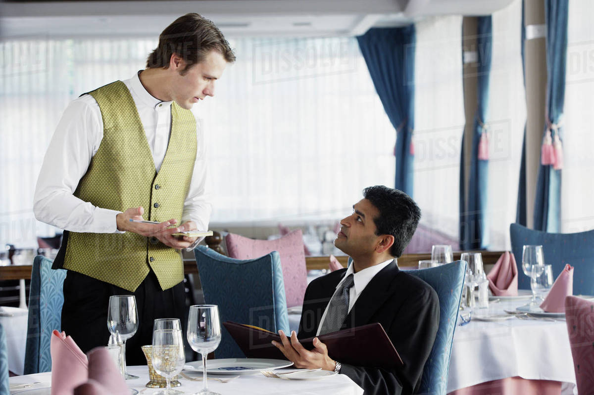 Man ordering food in a restaurant - Royalty-free Stock Photo | Dissolve