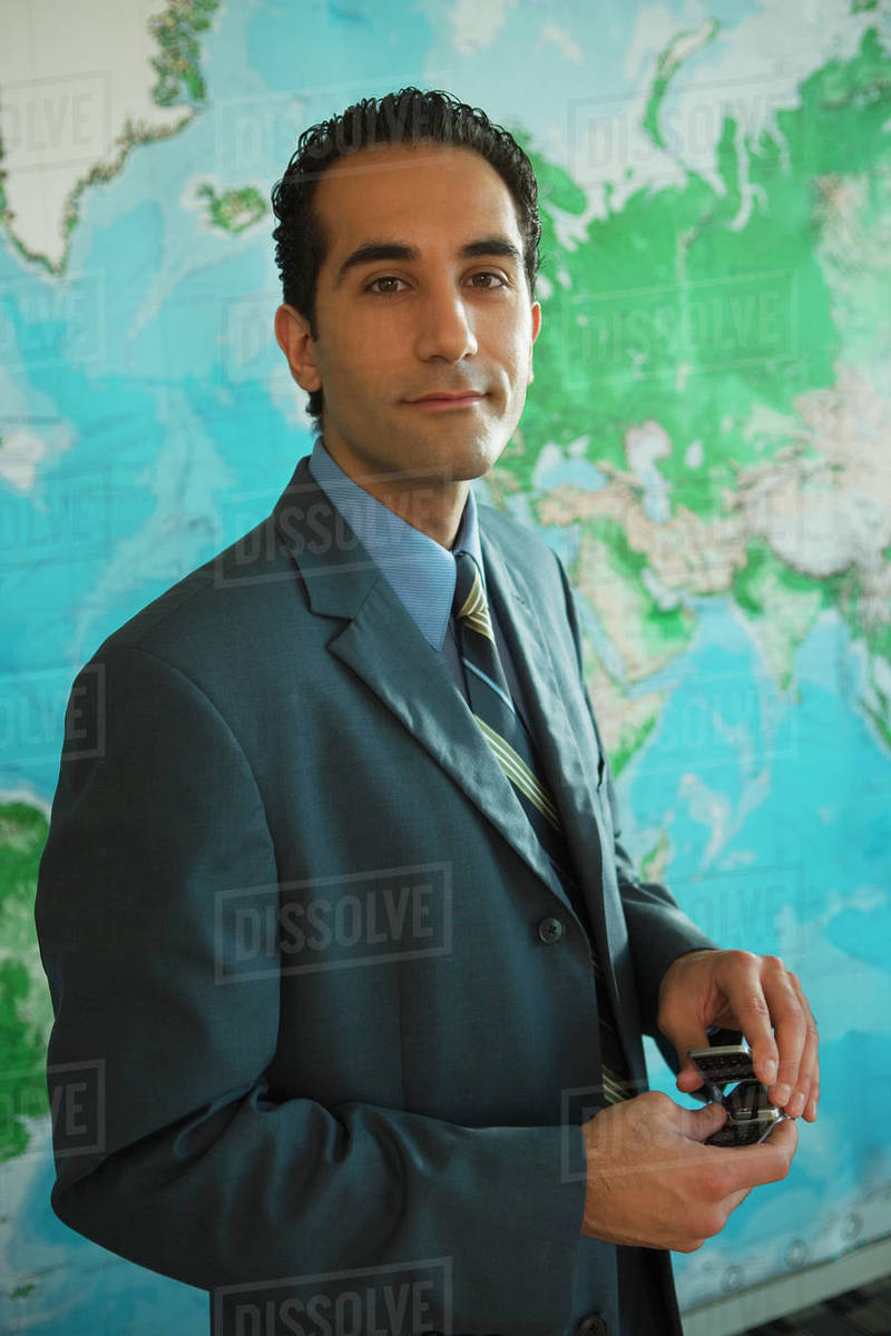 Serious Middle Eastern businessman with cell phone - Royalty-free Stock ...