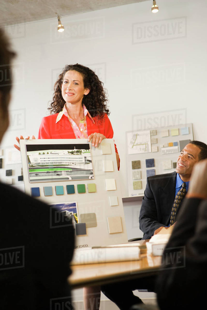 Caucasian interior designer giving presentation - Stock Photo - Dissolve