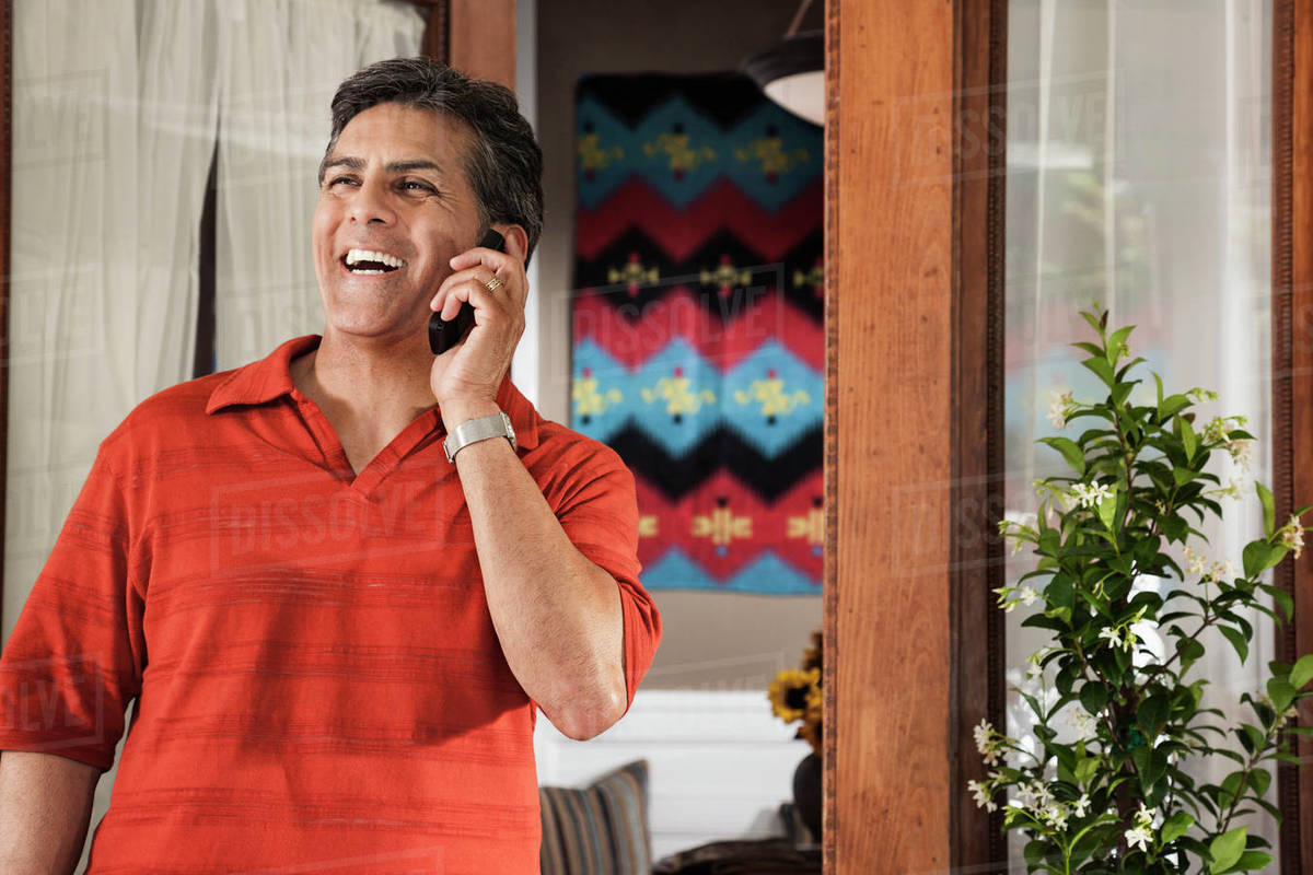 Hispanic man talking on cell phone - Royalty-free Stock Photo | Dissolve