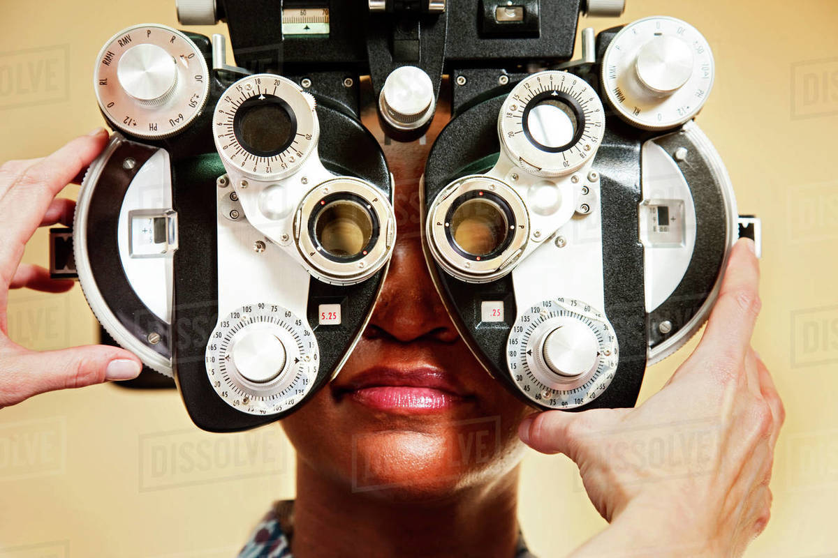 Optician adjusting equipment for patient - Royalty-free Stock Photo ...