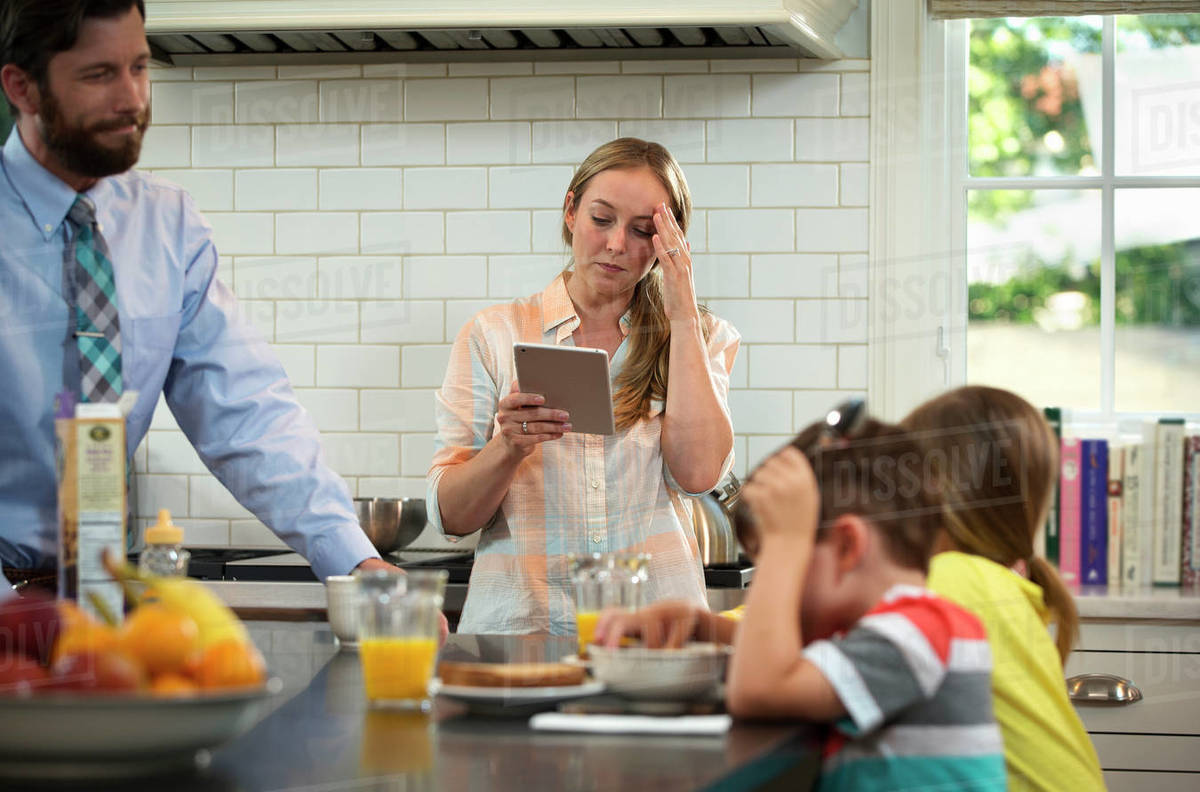 Mom with family in kitchen, struggling to get the kids breakfast and ...