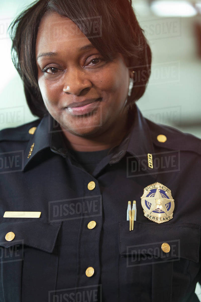 Portrait of Police woman Sergeant standing looking towards camera ...
