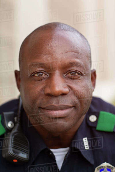 Close up Portrait of uniformed Police officer sitting outside looking ...