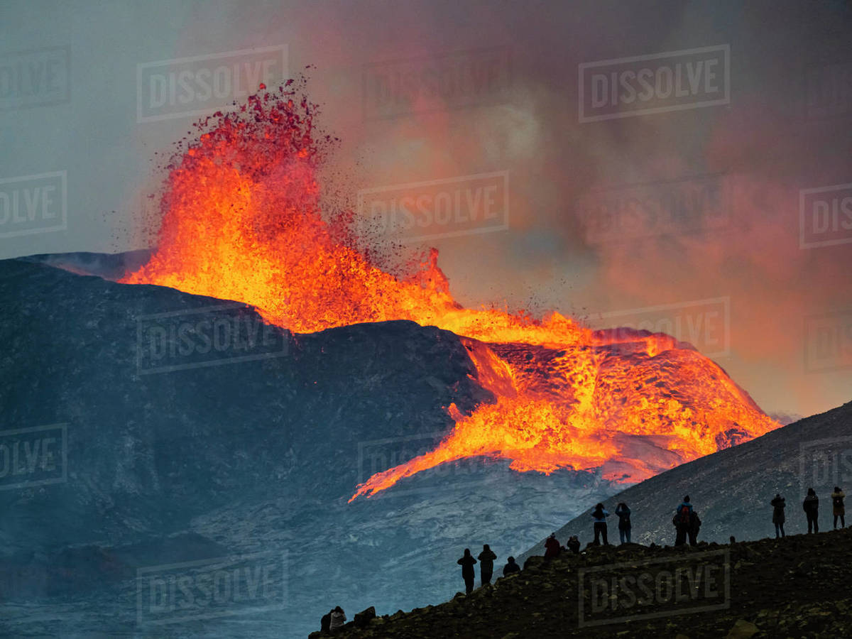 Hikers enjoy fireworks from Observation Hill as glowing lava is ejected ...