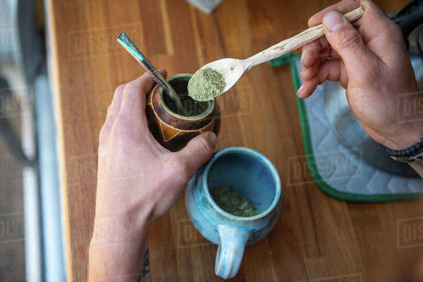 Overhead shot of man making morning herbal tea. - Stock Photo - Dissolve