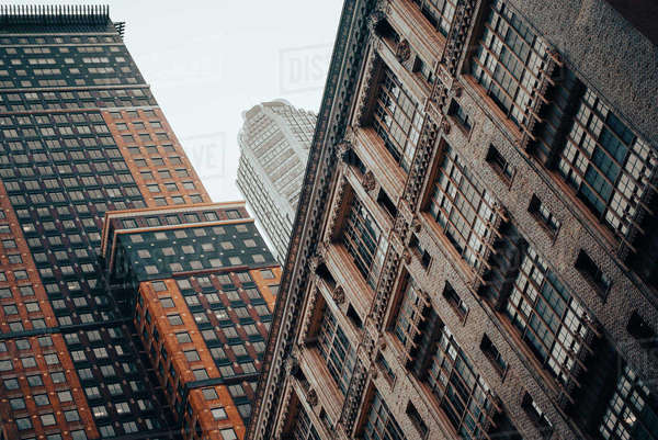 Two brick high rise buildings in Manhattan in front of a skyscraper on ...