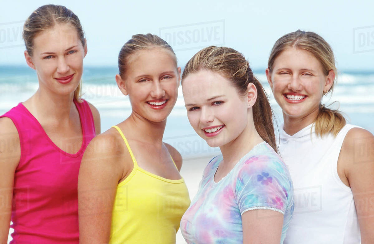 Four teenage girls up close and smiling at the beach - Stock Photo ...