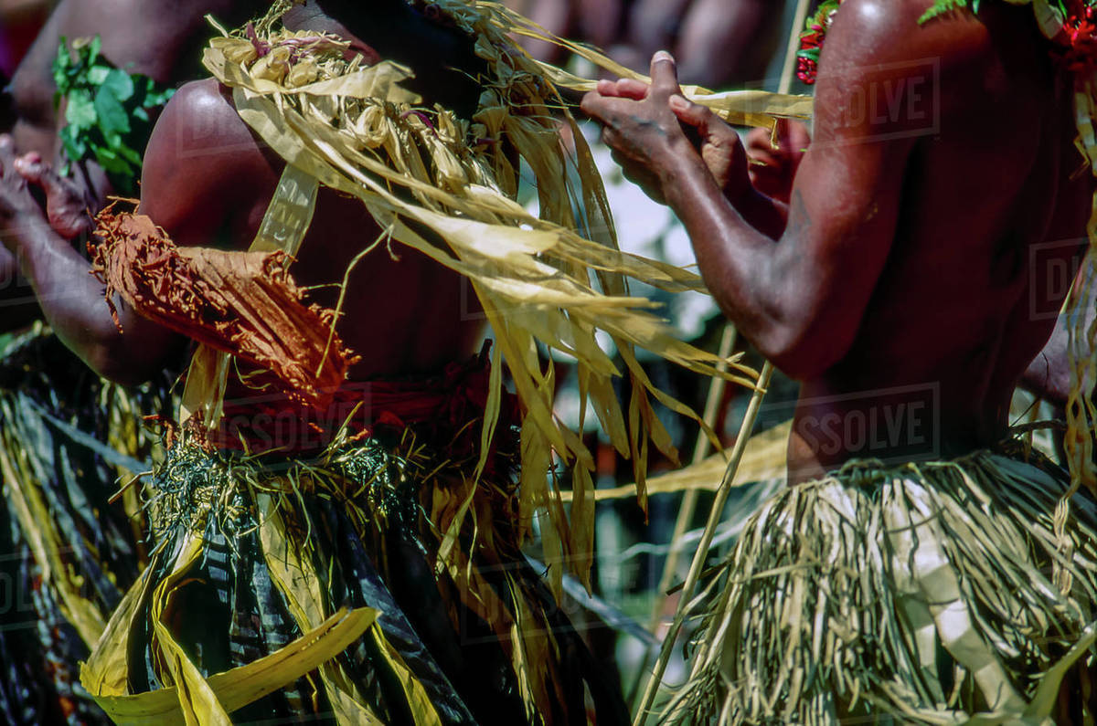 Native Fijian men dressed in traditional dress performing and dancing ...