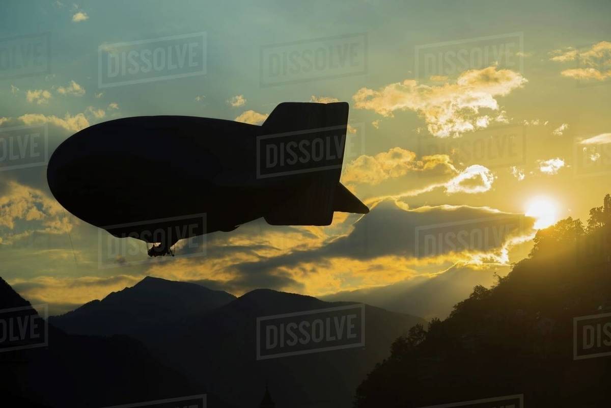 Blimp Flying over the Mountain in Sunset in Locarno, Switzerland ...